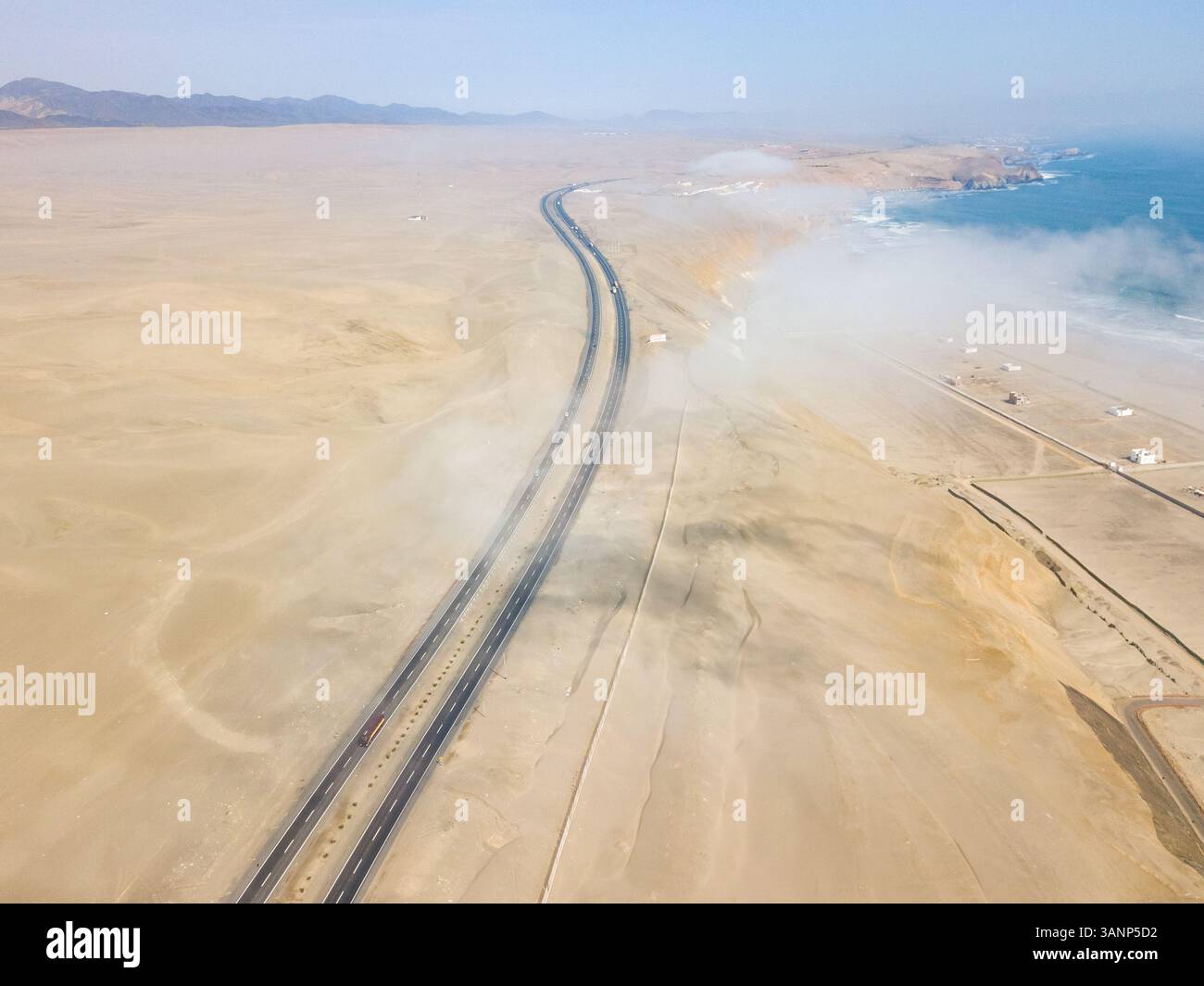 Aerial view of long curved road in desert by coast, Asia district, Peru ...