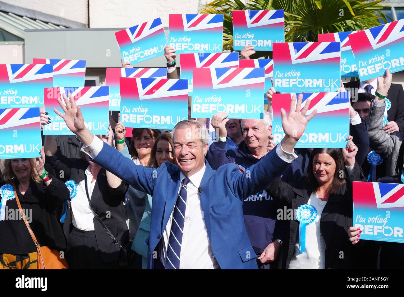 Reform UK leader Nigel Farage poses outside The Waterford Lodge ...