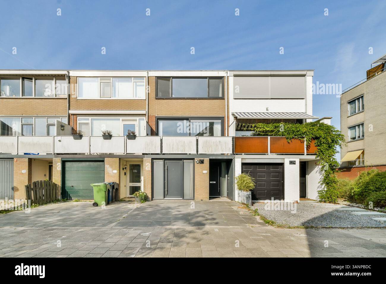 A modern residential building featuring sleek lines and a welcoming ...