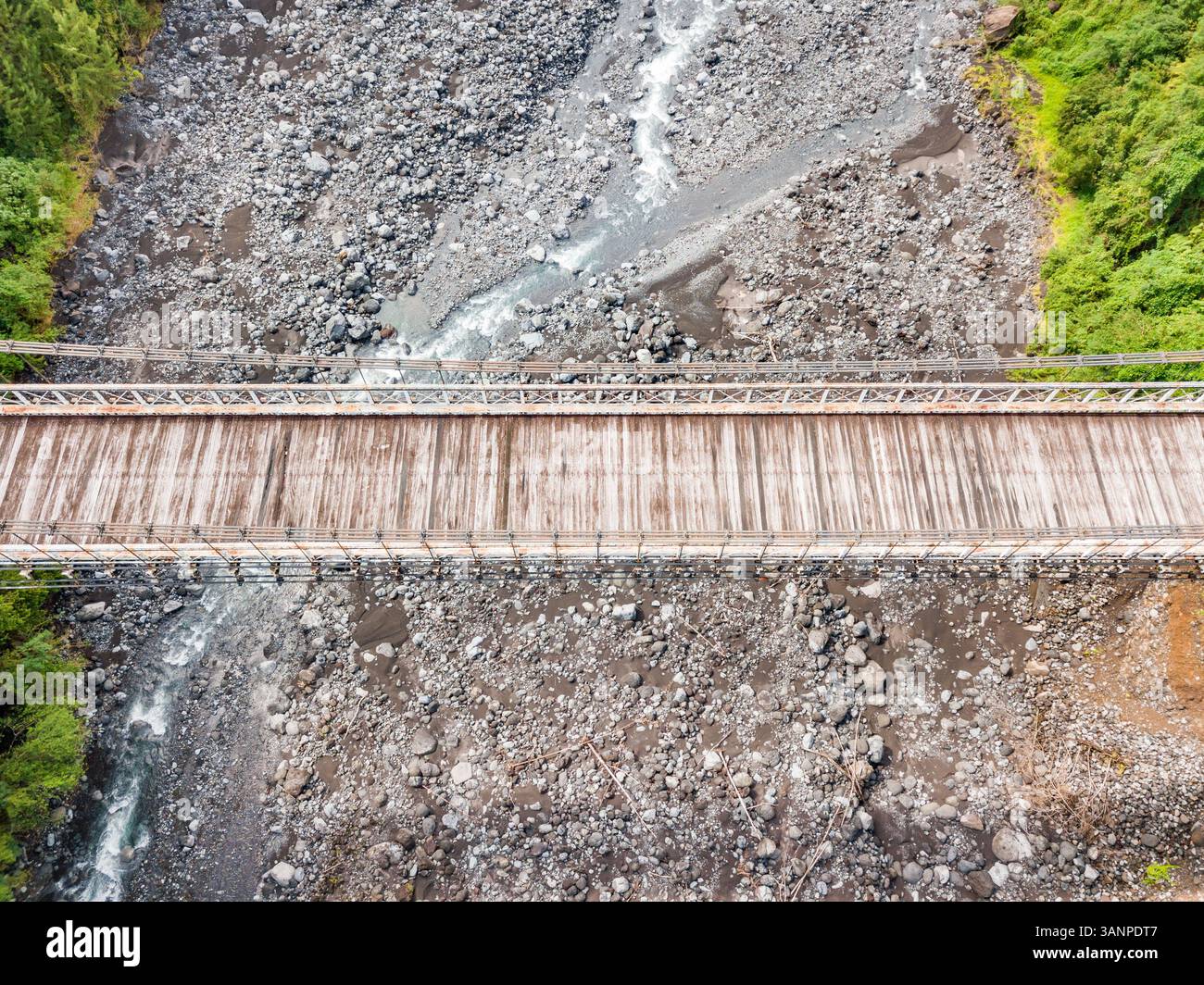 Aerial view of wooden suspension bridge over East River, Reunion island ...