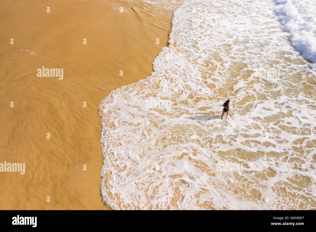 Aerial view of woman walking alone at hidden beach at Alexandria Bay ...