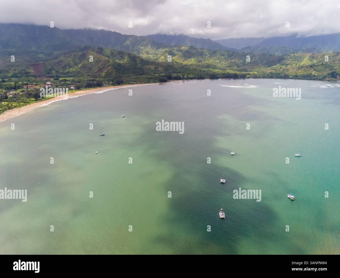 Aerial view faraway of Black Pot Beach surrounding by mountains, Hawaii ...