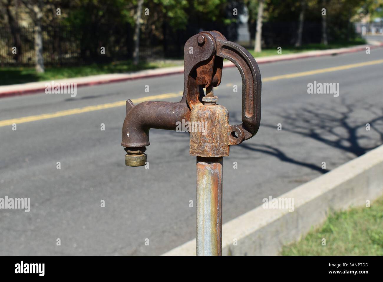 Old rusty faucet on the street, metal tap in a public in the city ...