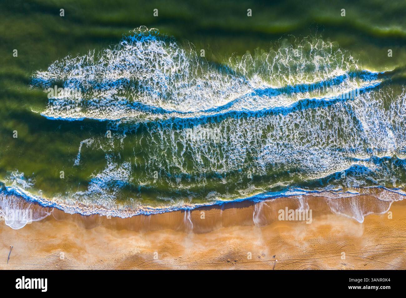 Aerial view of crispy waves of North Atlantic Ocean breaking on the ...