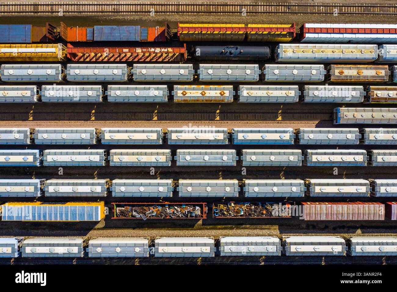 Aerial view of rail cars waiting at a staging railyard station in ...