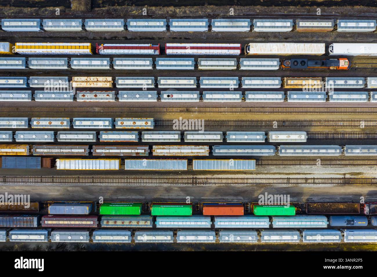 Aerial view of rail cars waiting at a staging railyard station in ...