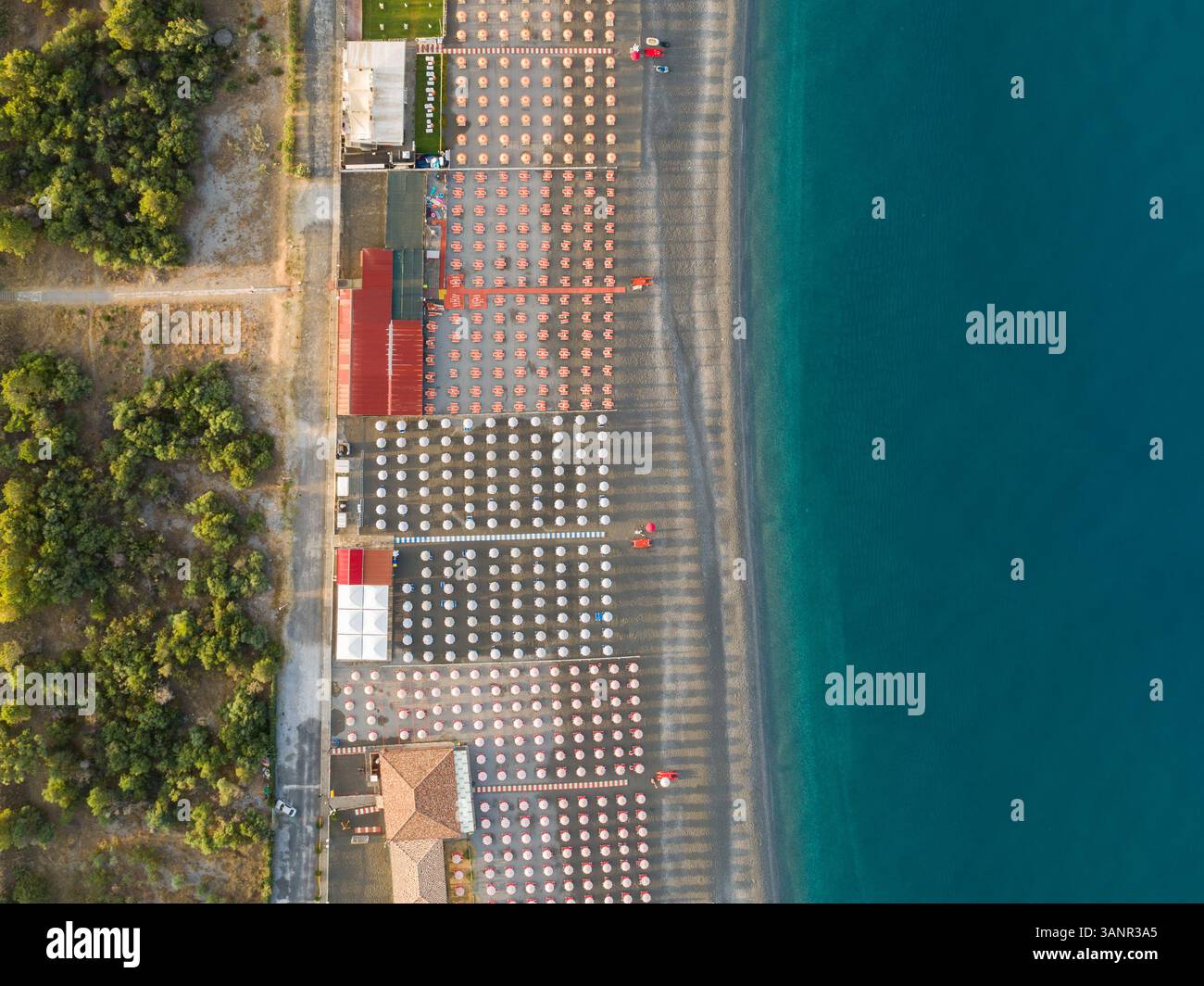 Aerial view of the seashore with parasols and sunbeds in Scalea ...