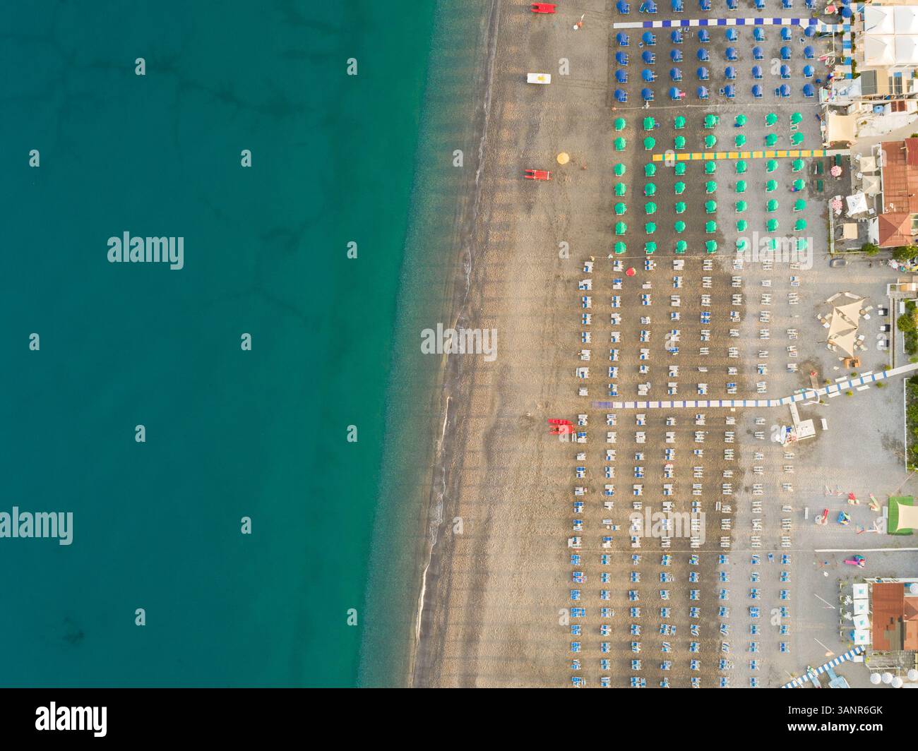 Aerial view of the seashore with parasols and sunbeds in Scalea ...