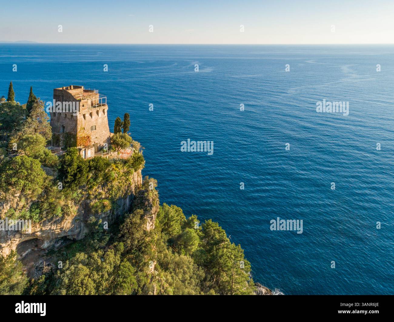 Aerial view of an ancient tower on the rocks in front of sea on Amalfi ...