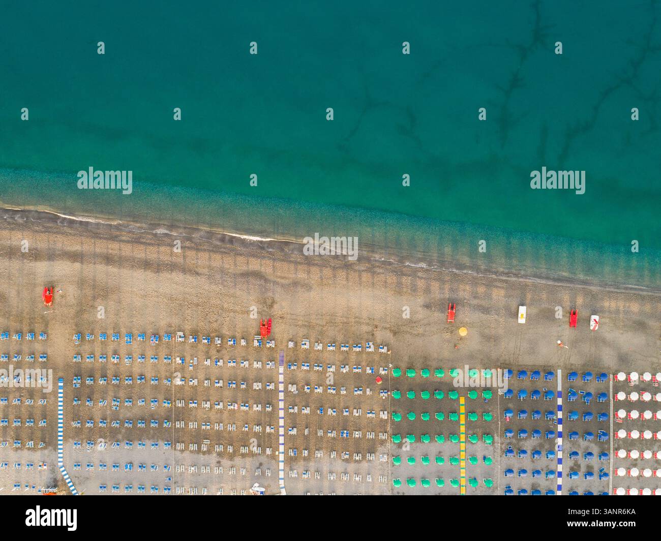 Aerial view of the seashore with parasols and sunbeds in Scalea ...