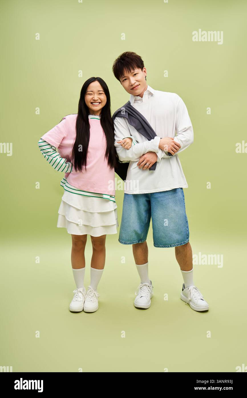 A lovely couple stands close together, radiating joy and fashion flair in bright attire Stock ...