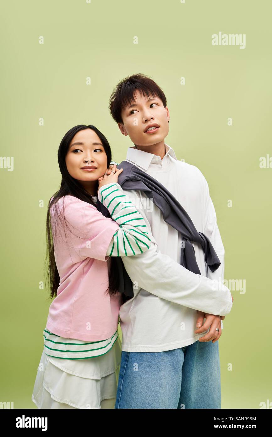 A fashionable couple stands close together, radiating love and style in ...
