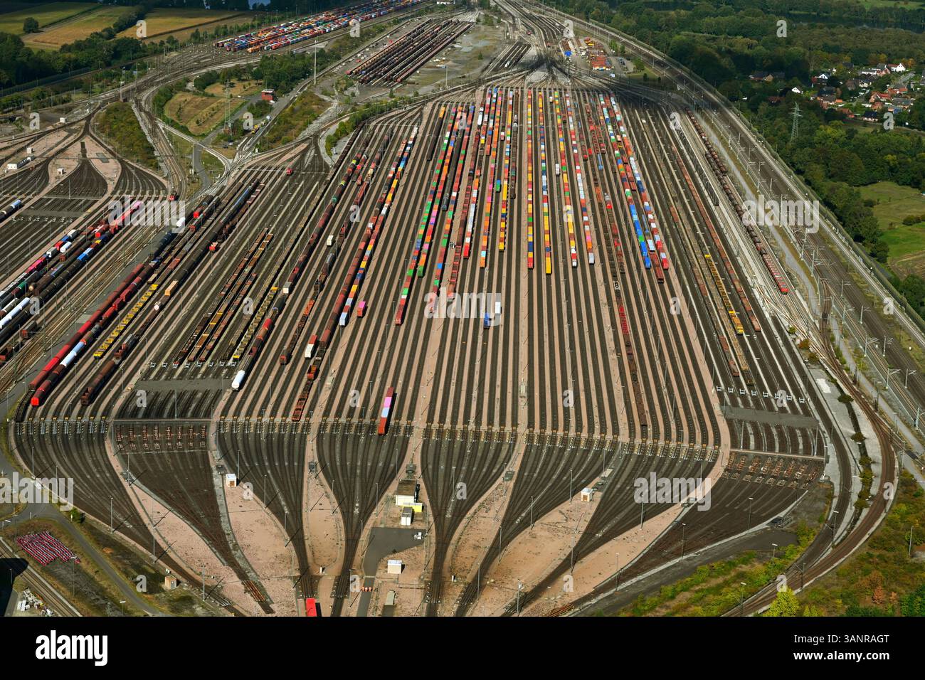 Aerial view of a bustling train depot with cargo containers and railway ...