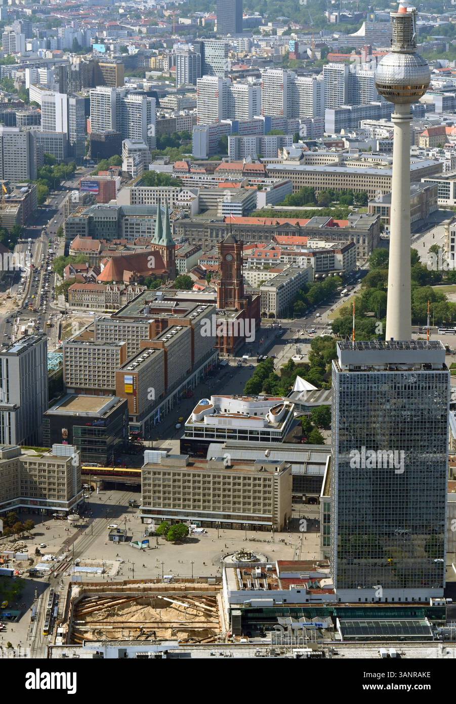 Aerial view of bustling cityscape with tower cranes and highrise ...
