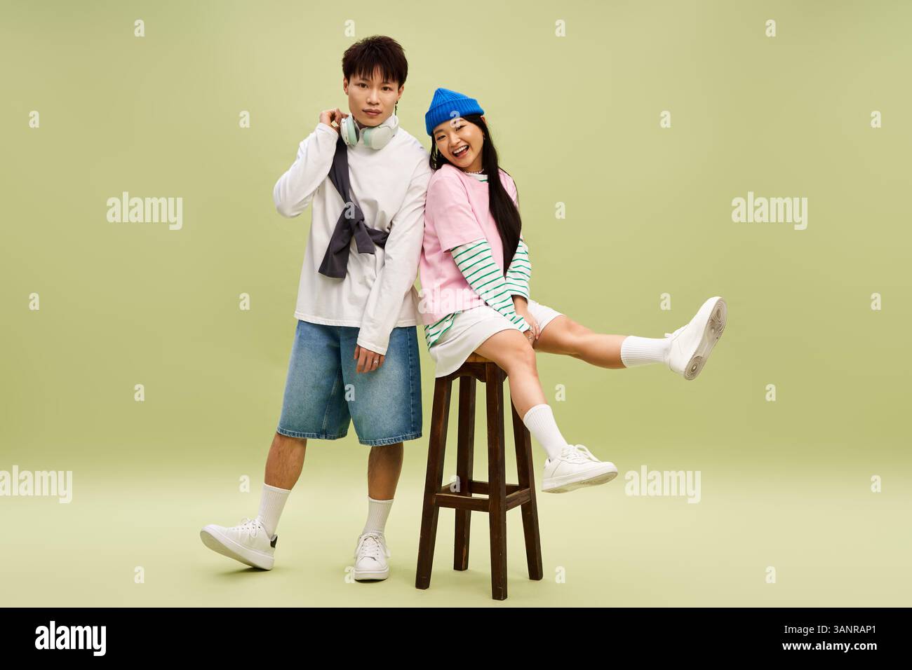 Stylish couple poses playfully, radiating love and energy in matching ...