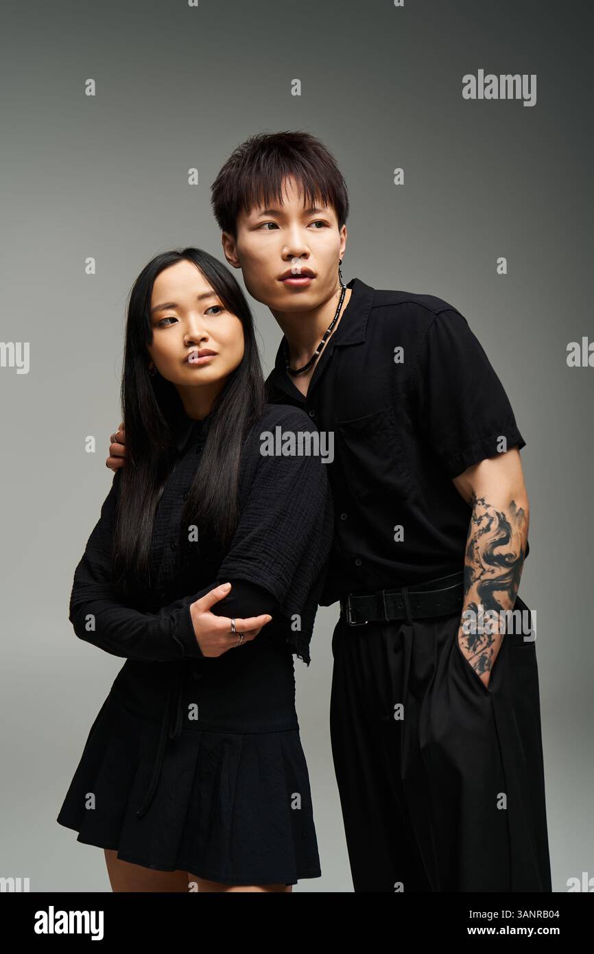 A stylish couple stands closely together, reflecting love and ...