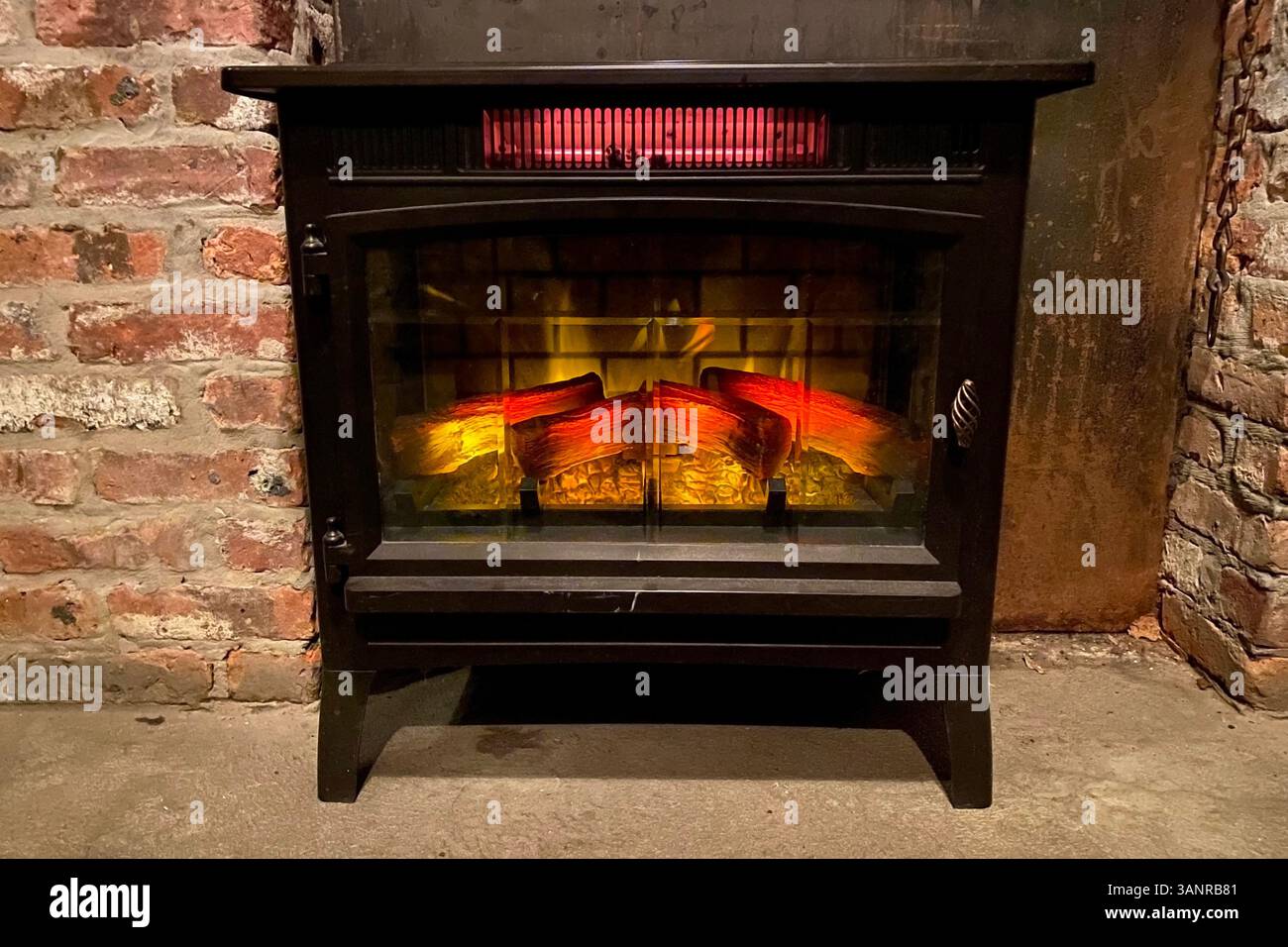 Burning fireplace against a brick wall Stock Photo - Alamy