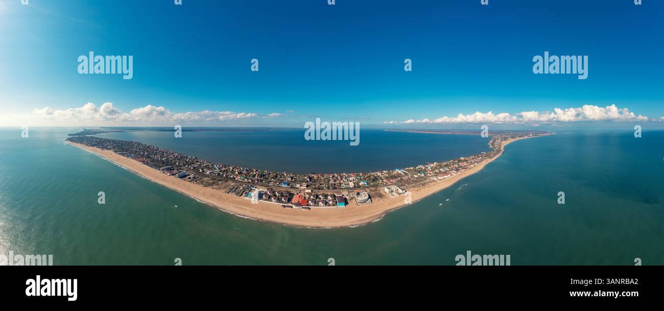 Aerial view of the spit in the sea in daylight. Top view of the sea and ...