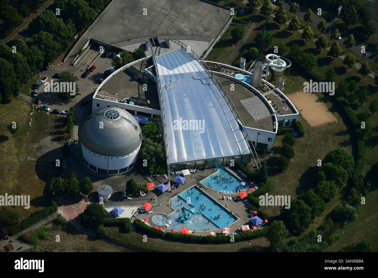 Aerial view of a modern swimming pool with people swimming surrounded ...