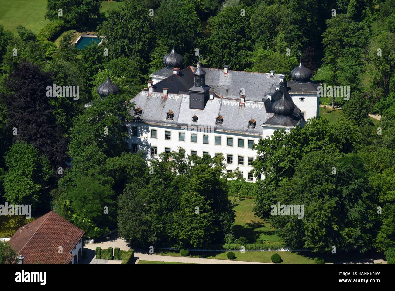 Aerial view of Schloss Moos palace surrounded by lush greenery and ...