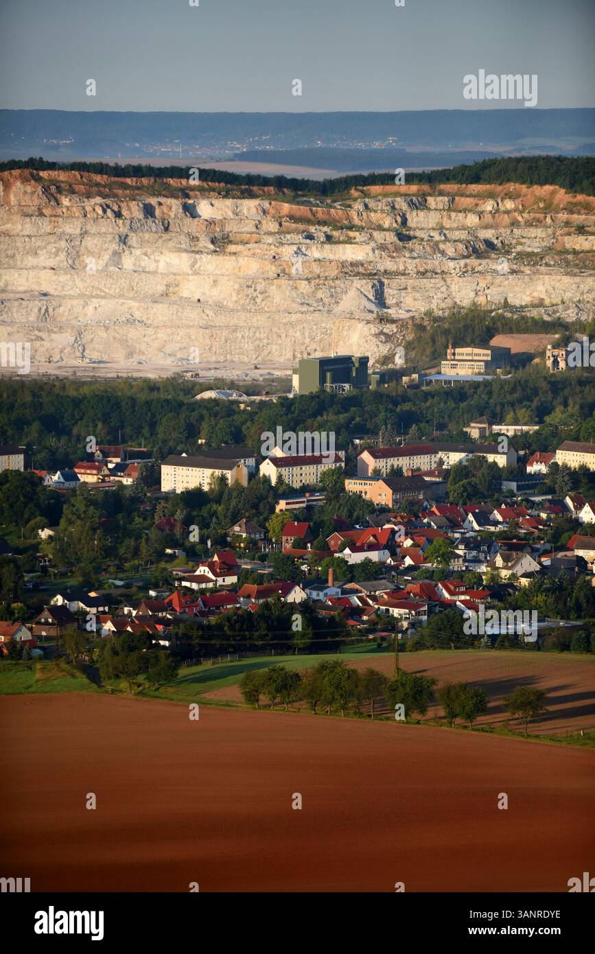 Aerial view of a picturesque village with homes and fields amidst lush ...