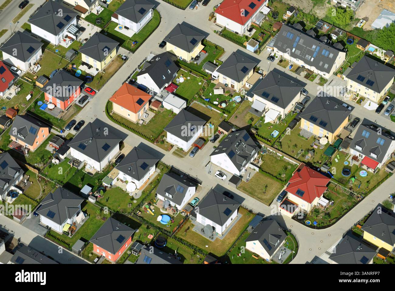 Aerial view of suburban neighborhood with organized rooftops and green ...