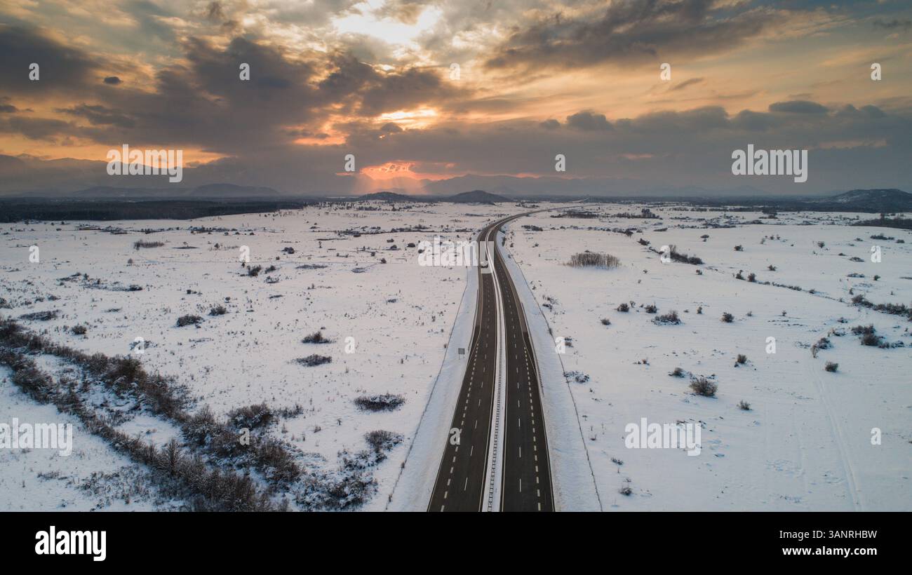 Aerial view of winter sunset and snow at A1, main motorway in Croatia ...