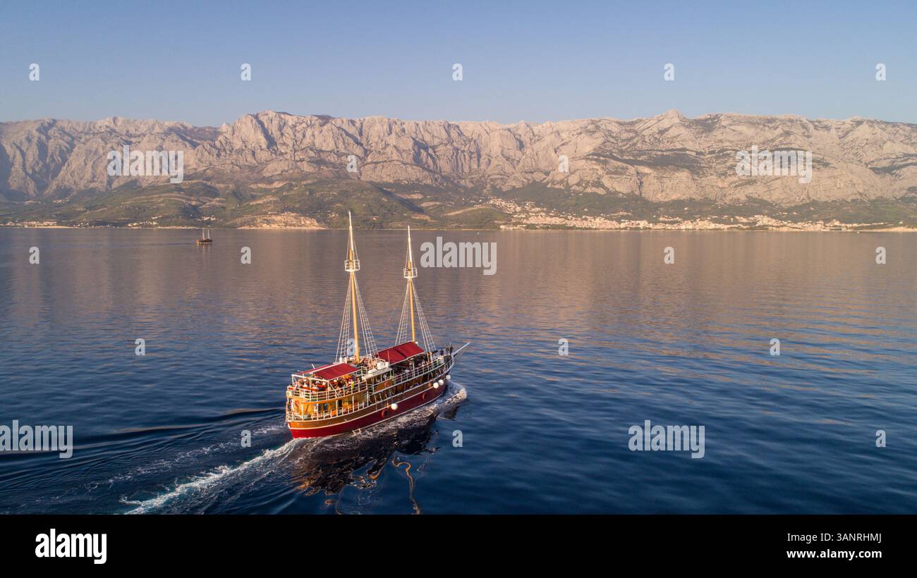 Aerial view of tourist boat on Adriatic sea near Makarska city and Hvar ...