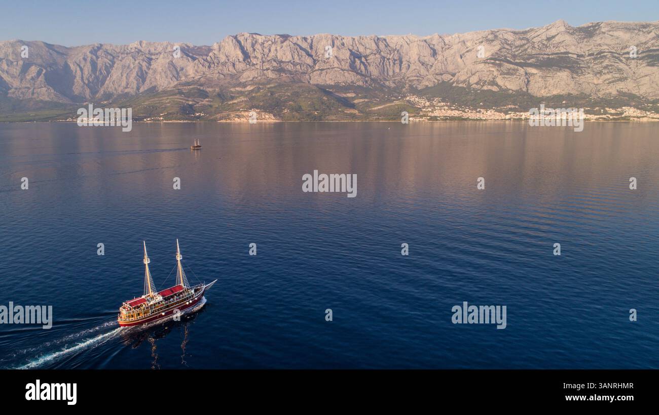 Aerial view of tourist boat on Adriatic sea near Makarska city and Hvar ...