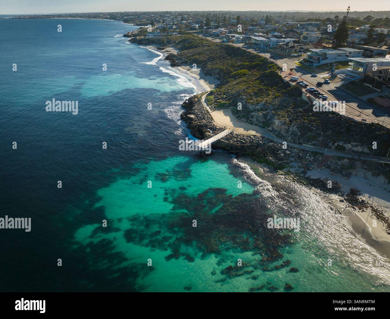 Aerial view of clear turquoise water and rocky shore at North Beach ...