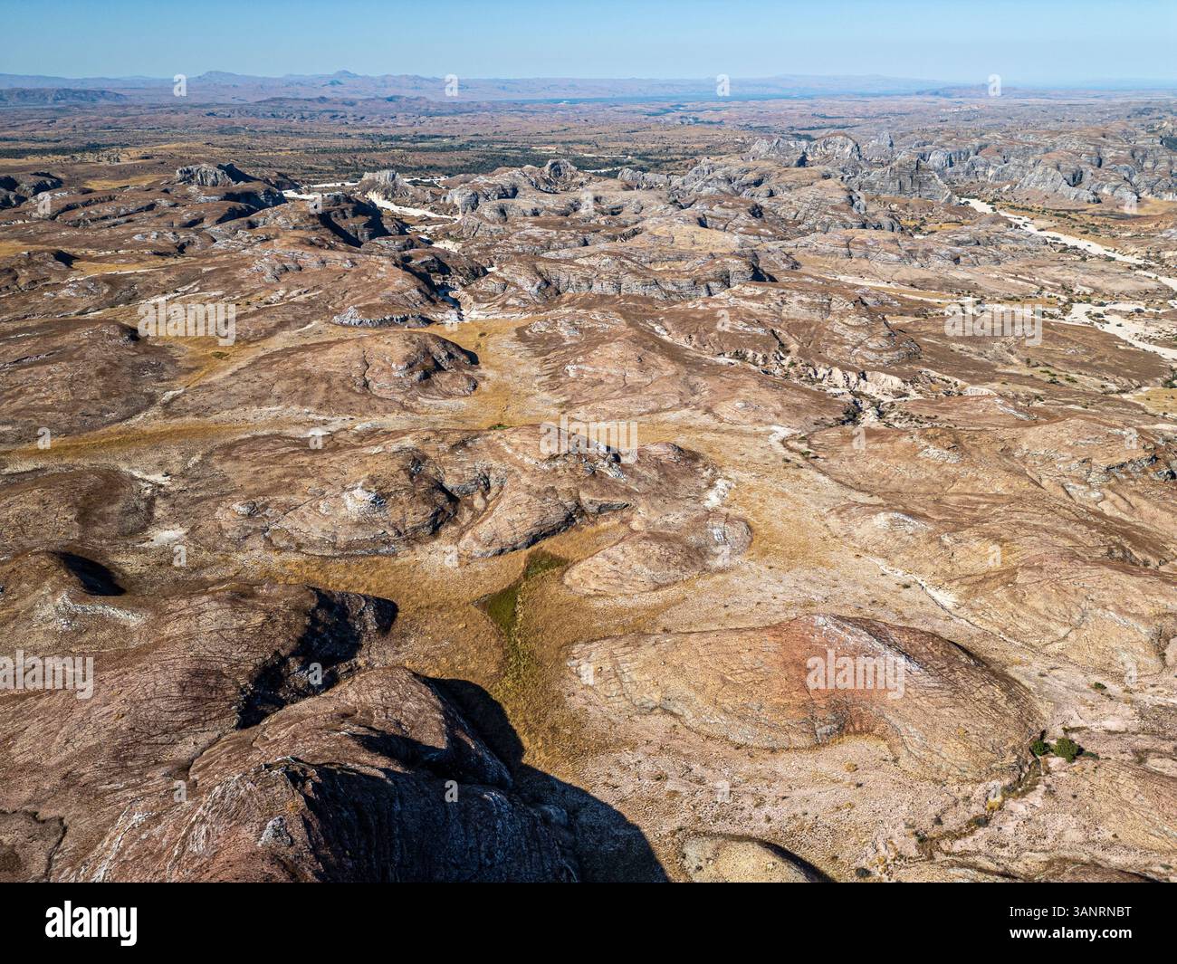 Aerial view of rocky and barren terrain with rugged geological ...