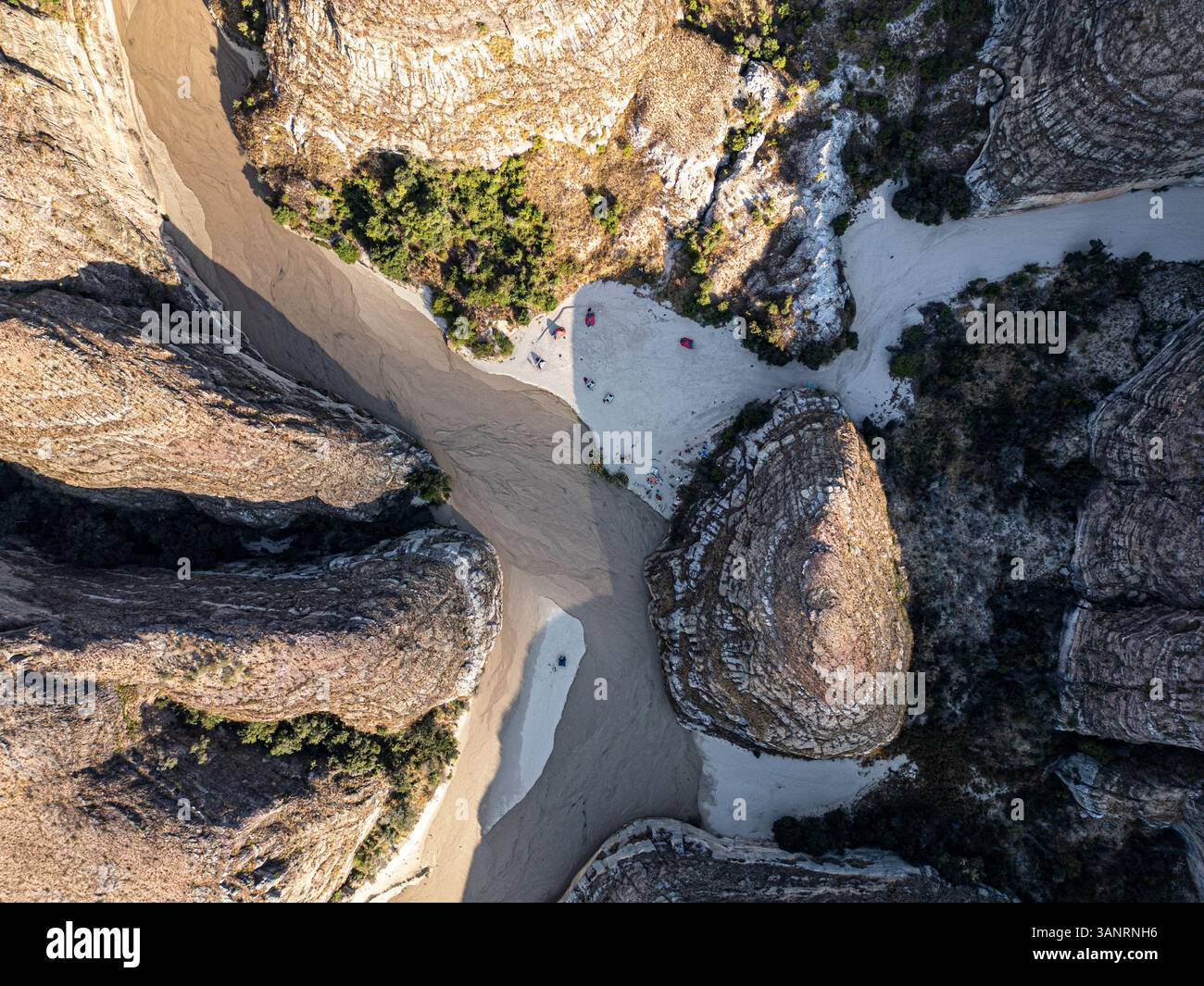Aerial view of winding river through majestic rock formations and ...