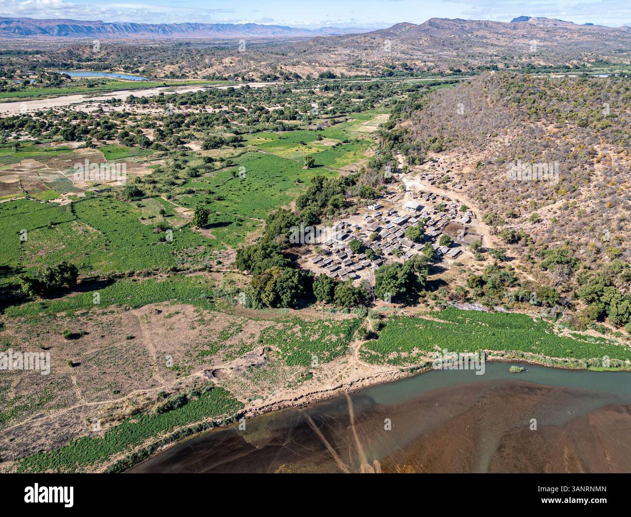Aerial view of a scenic village surrounded by lush greenery, fields ...