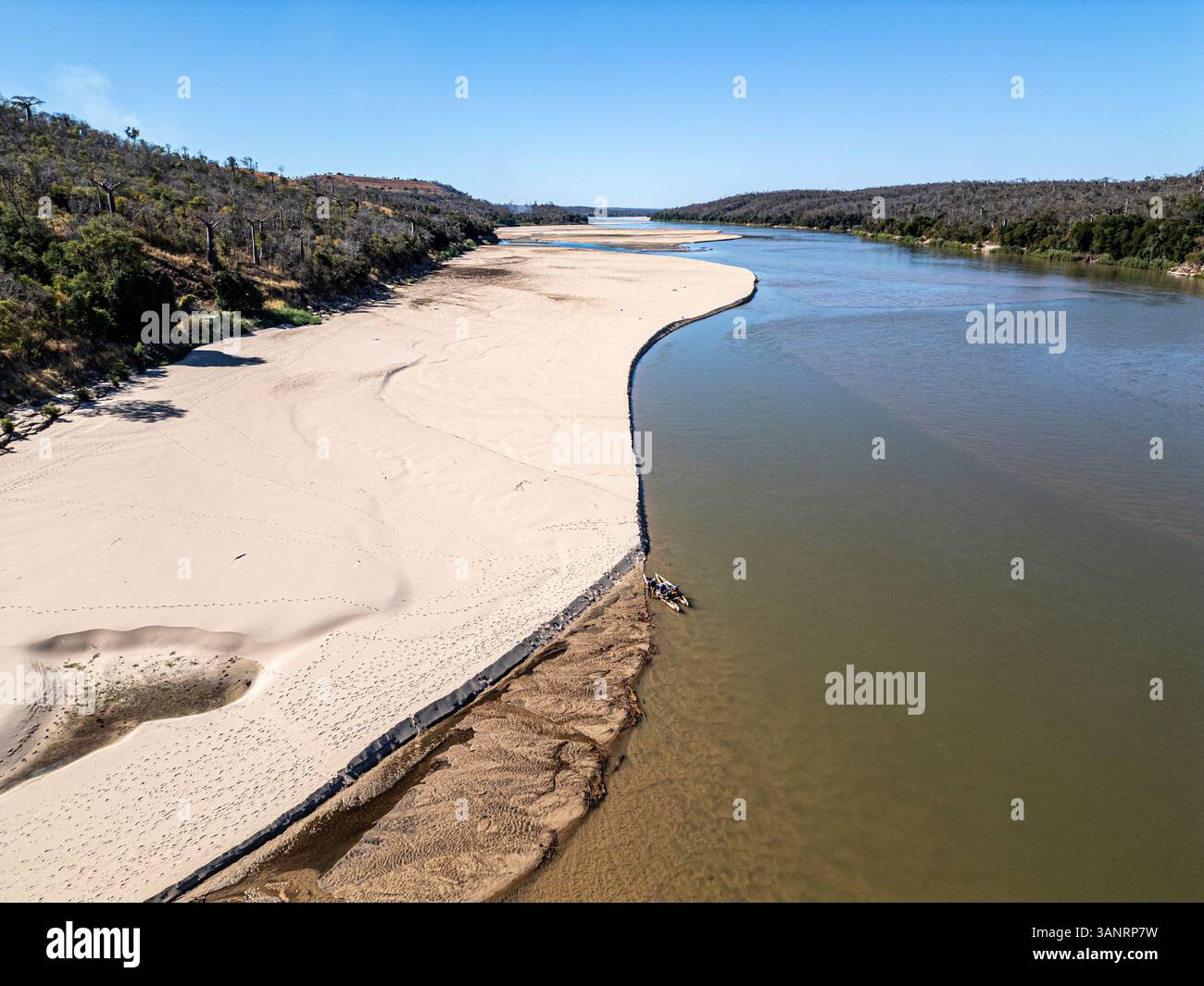 Aerial view of serene river winding through unspoiled sand beach and ...