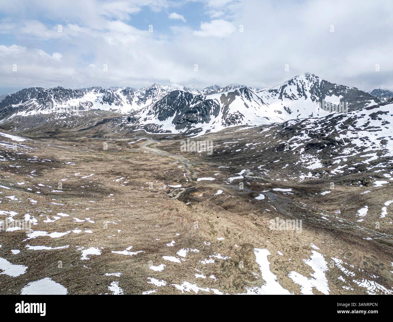 Aerial view of majestic snow-covered mountains in pristine Deosai ...