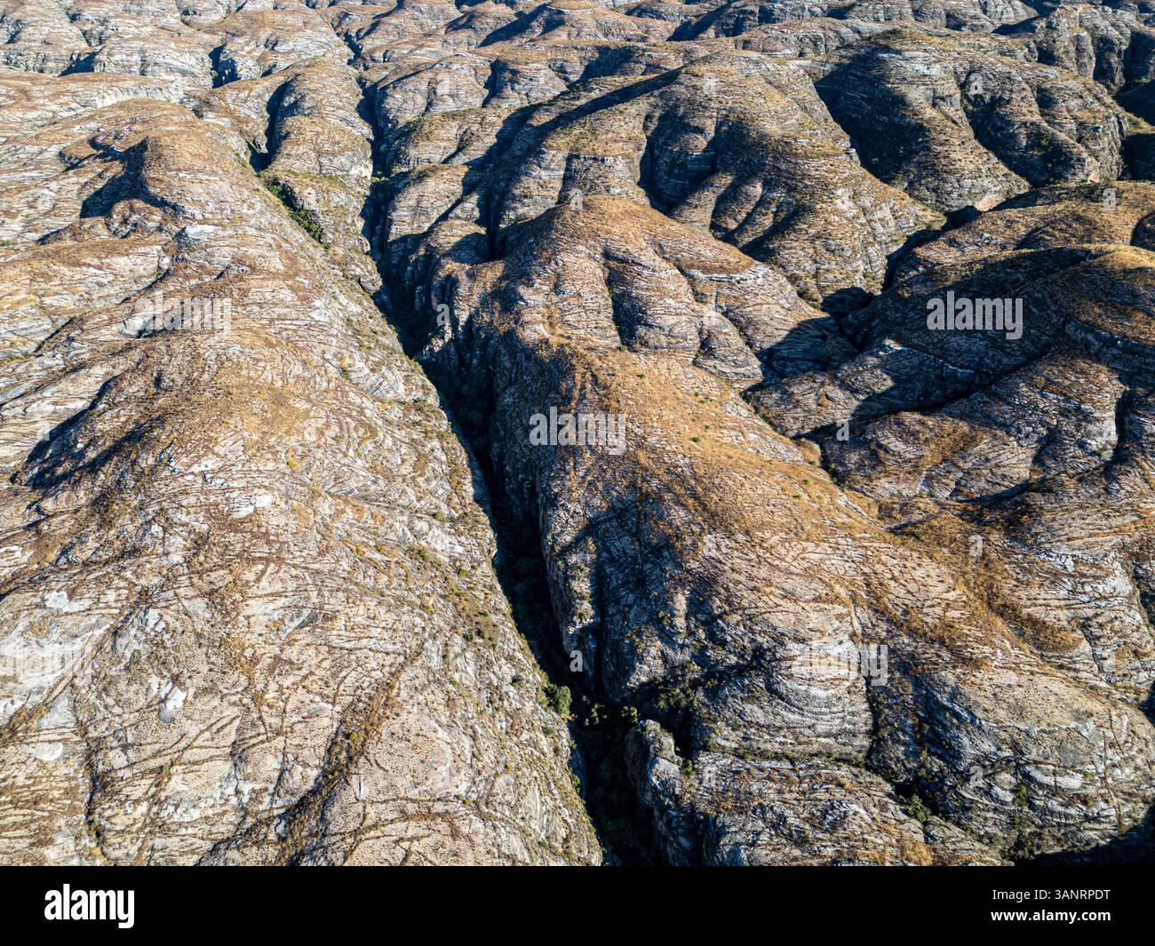 Aerial view of majestic and rugged mountains and valleys with a ...