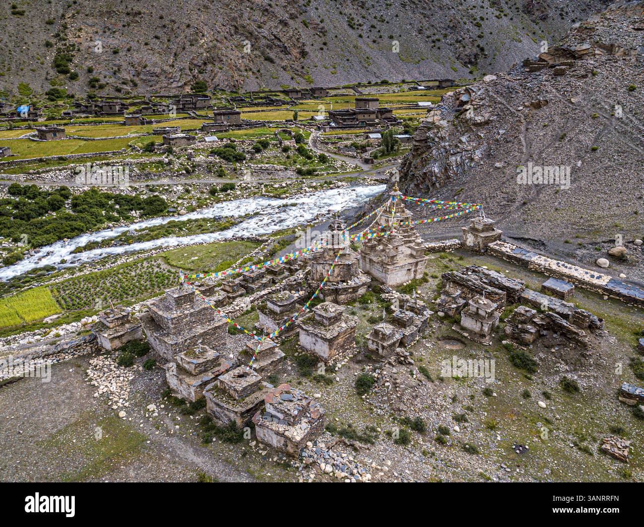 Aerial view of remote mountain village with terraced fields and stone ...
