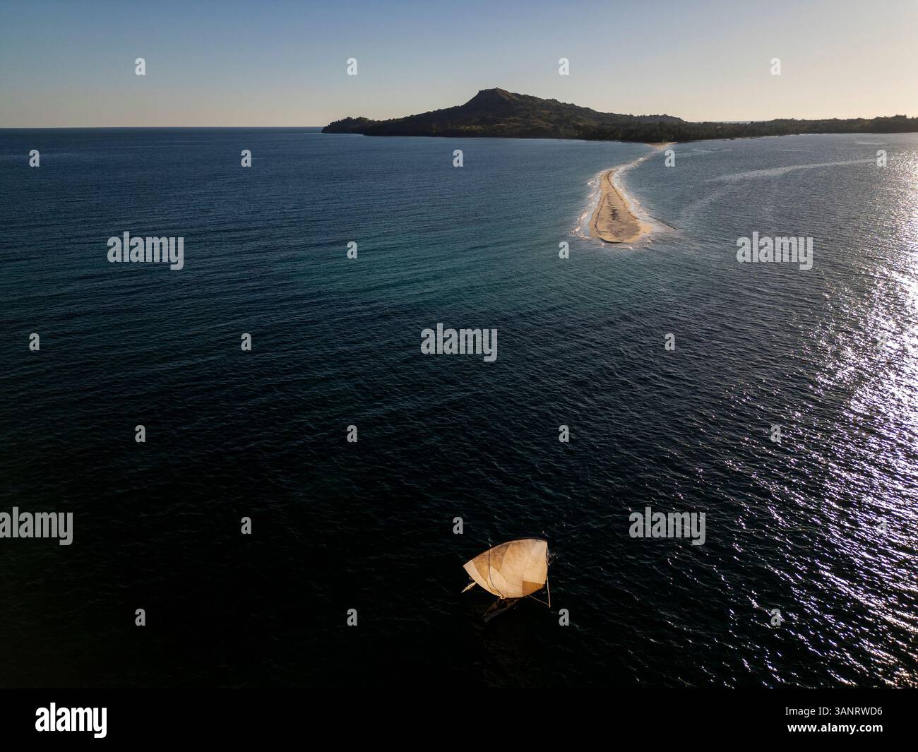 Aerial view of tropical island with outrigger canoe and sandy shores ...