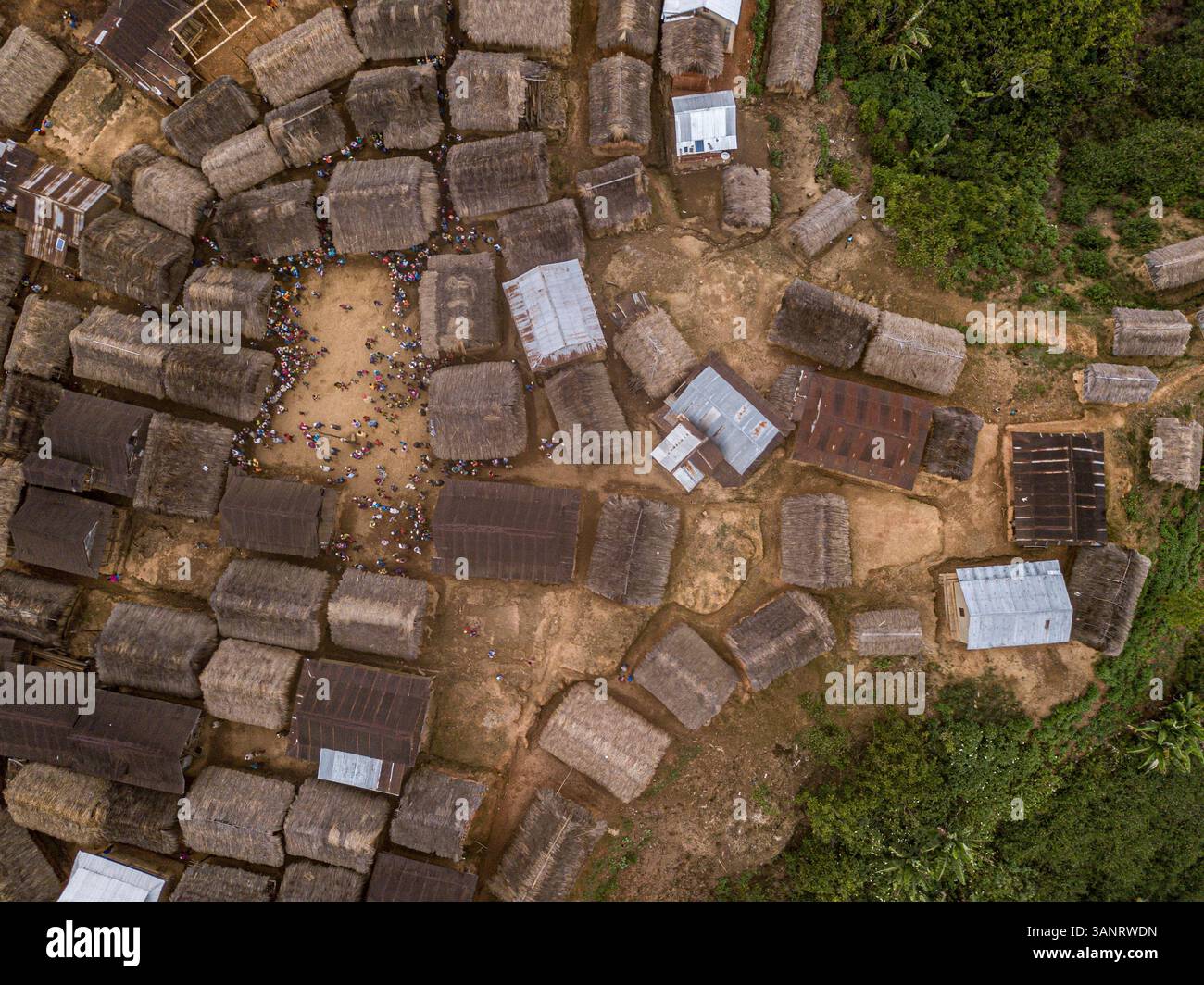 Aerial view of traditional village with thatched roofs and greenery in ...