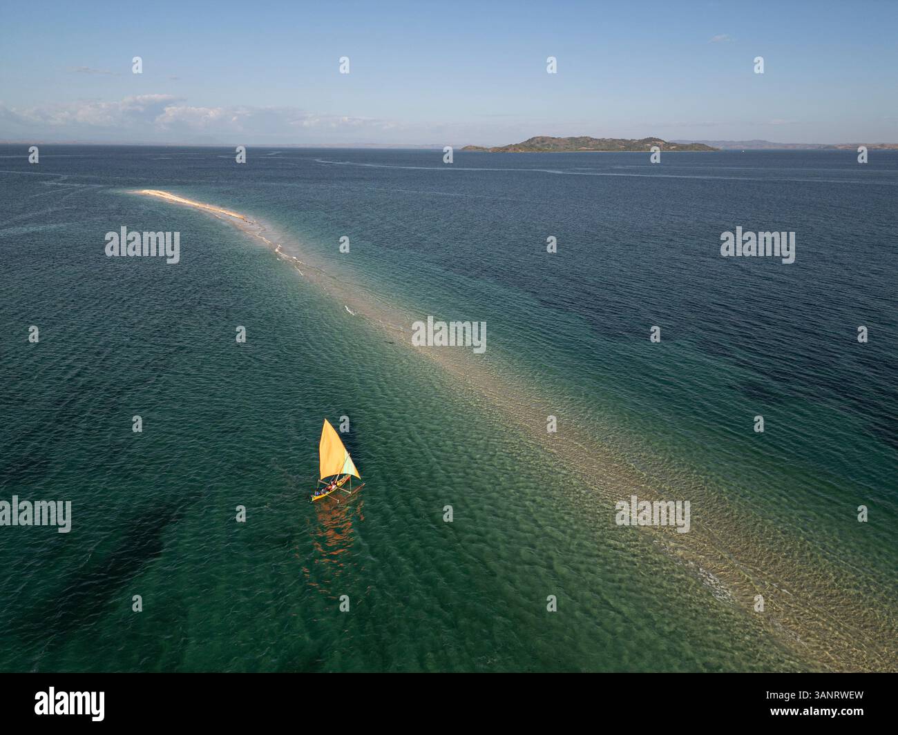 Aerial view of remote Nosy Lava Island with outrigger canoe and clear ...