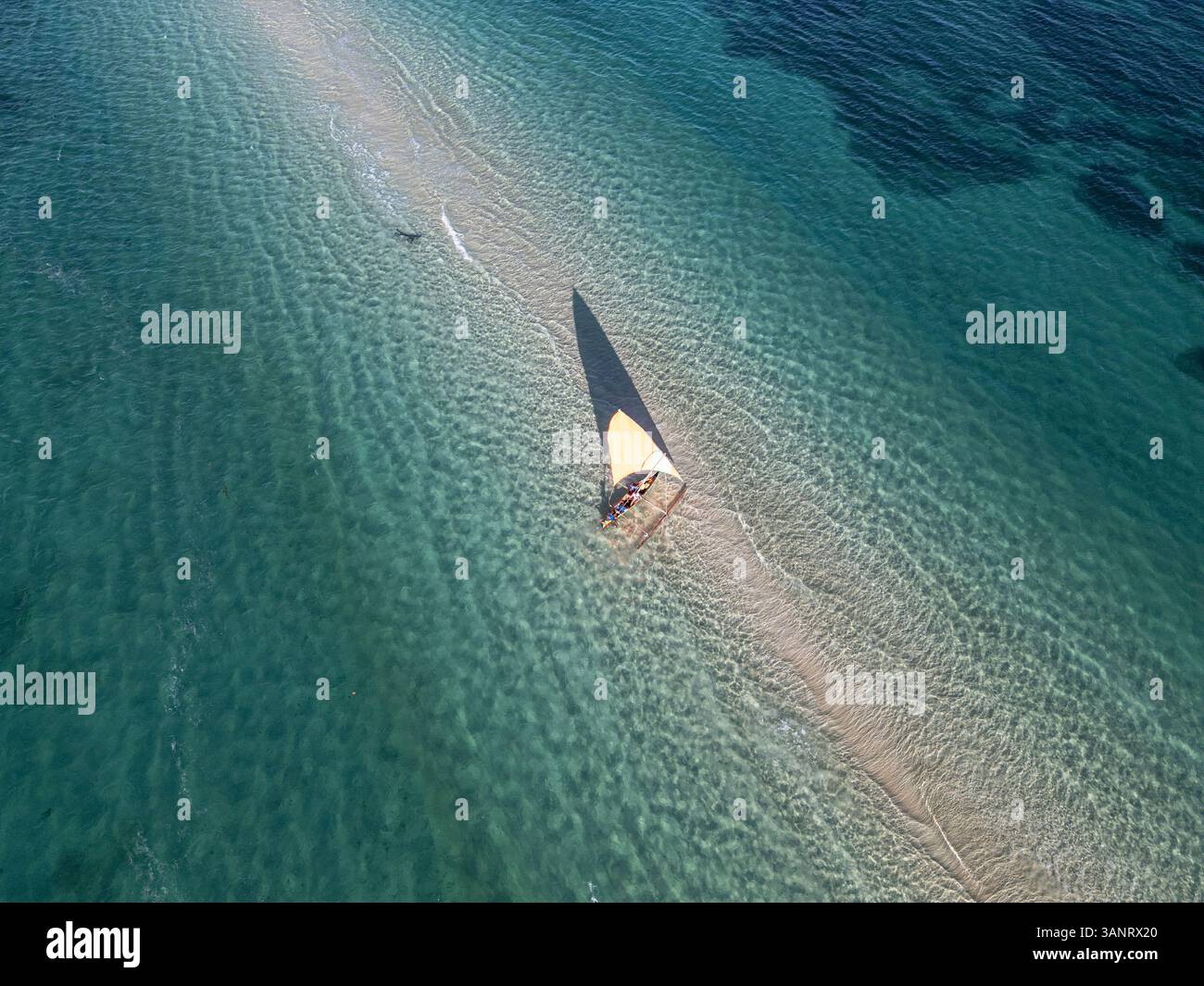Aerial view of tranquil Nosy Lava Island with outrigger canoe and clear ...