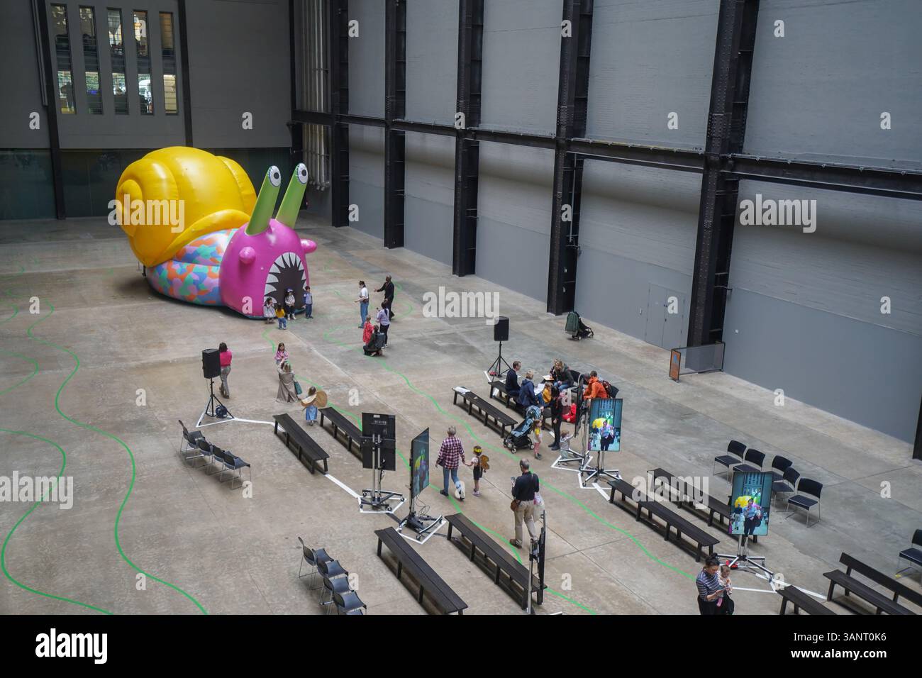 London UK 15 April 2025. Visitors interact with a larger-than-life ...