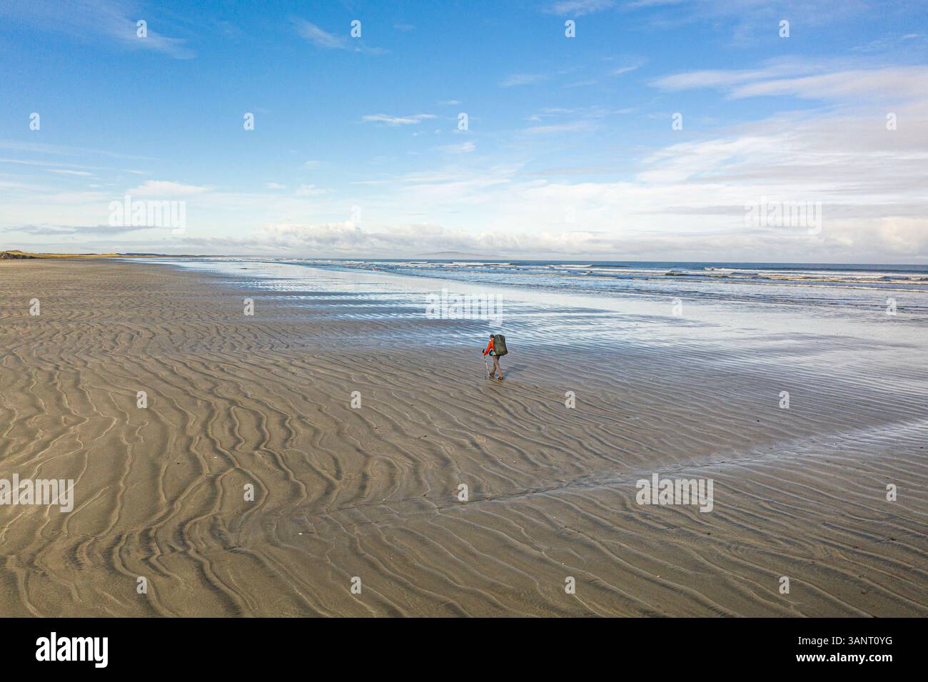Aerial view of moody coastal landscape with sandy beach and ocean waves ...