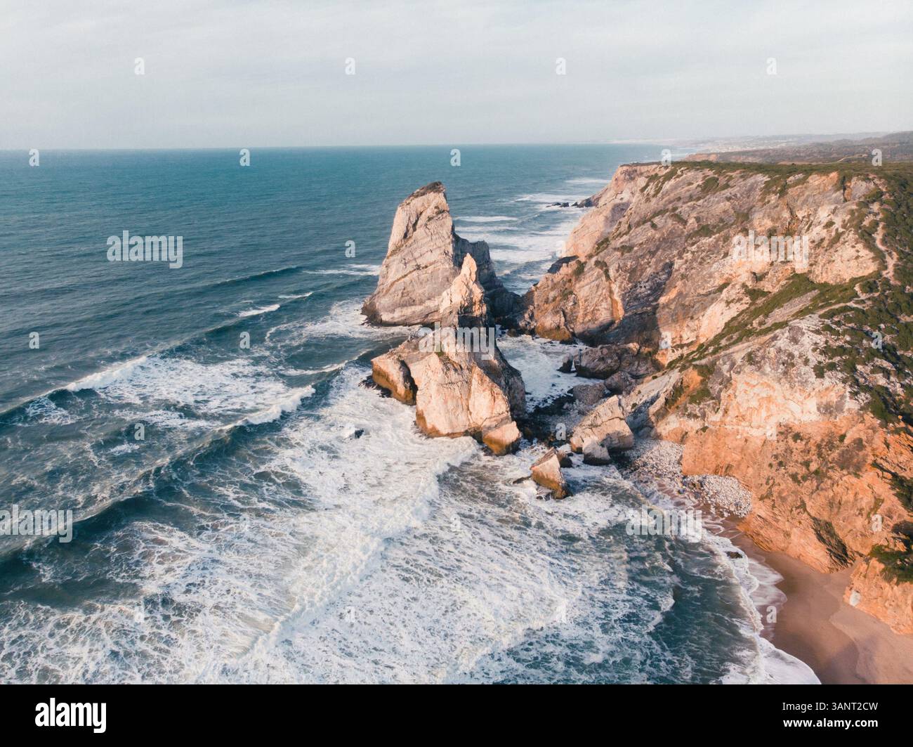 Aerial view of rocks in the Atlantic Ocean at Praia da Ursa, Lisbon ...