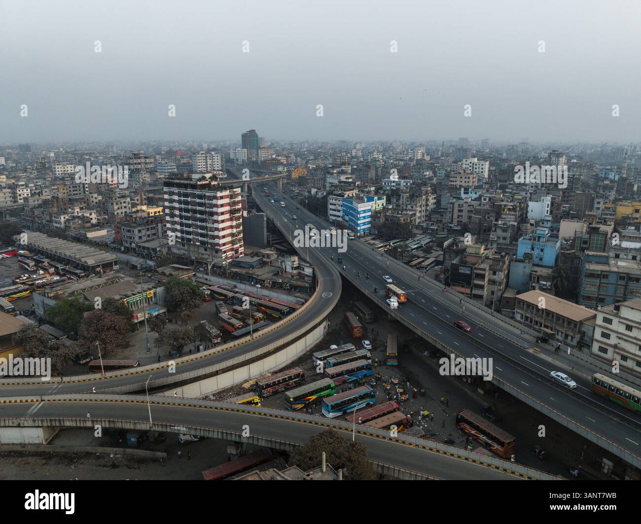 Aerial view of bustling junction road and bus station surrounded by ...