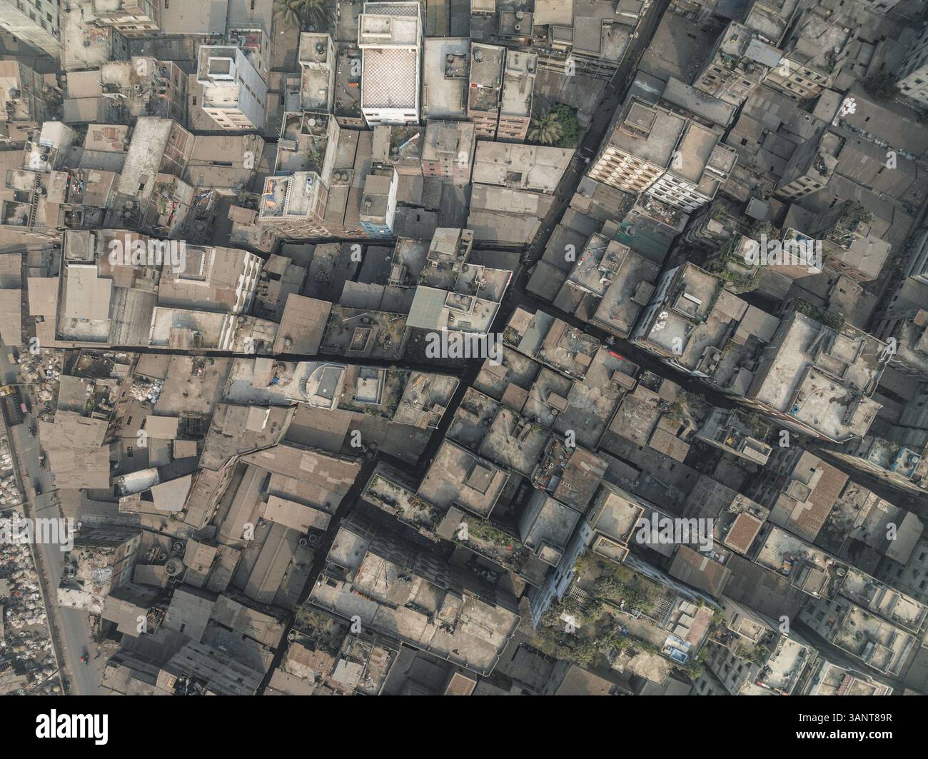 Aerial view of dense urban rooftops and buildings with a complex street ...