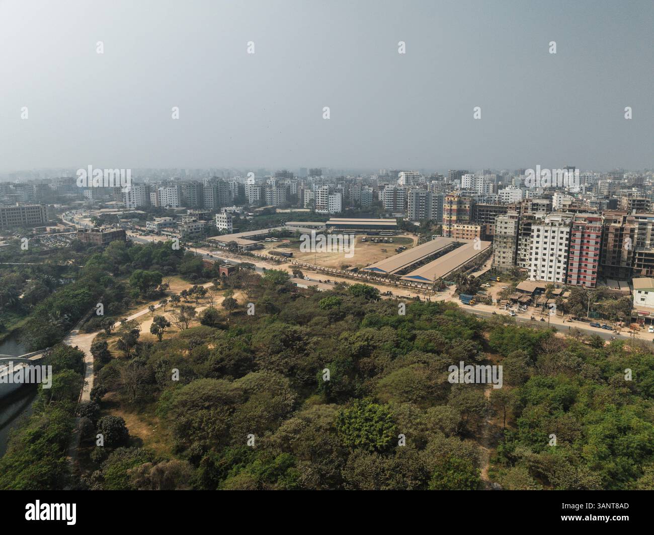 Aerial view of bustling cityscape with high-rise buildings and greenery ...