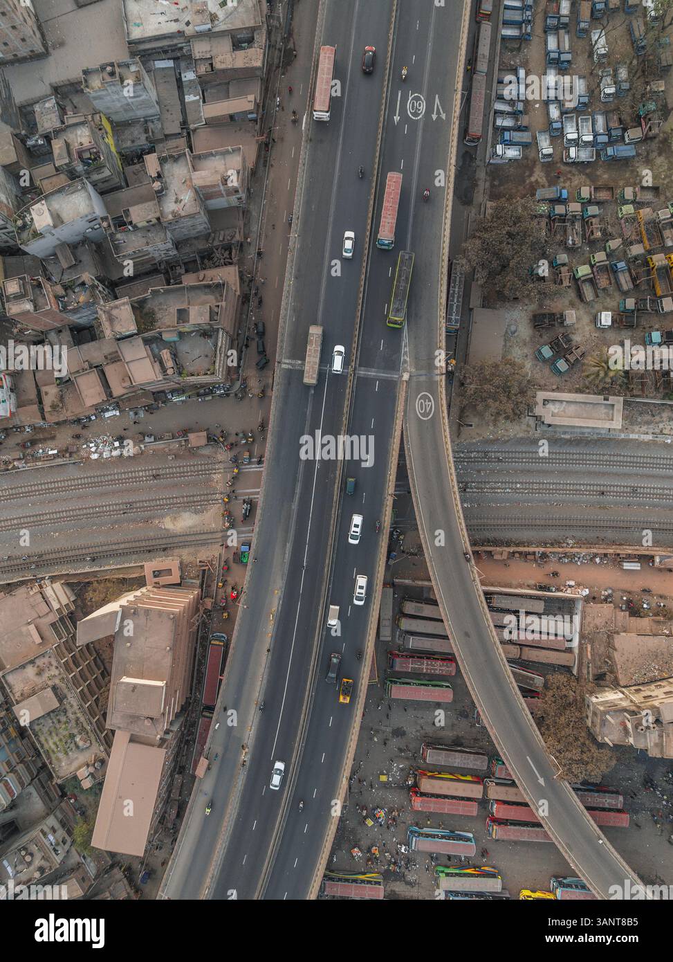 Aerial view of bustling junction road and bus station with busy traffic ...