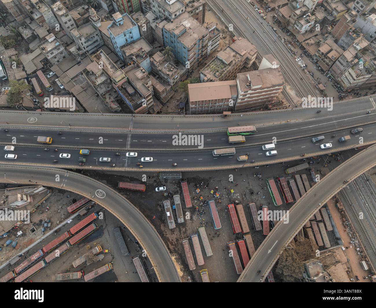 Aerial view of busy junction road with a bus station and dense urban ...