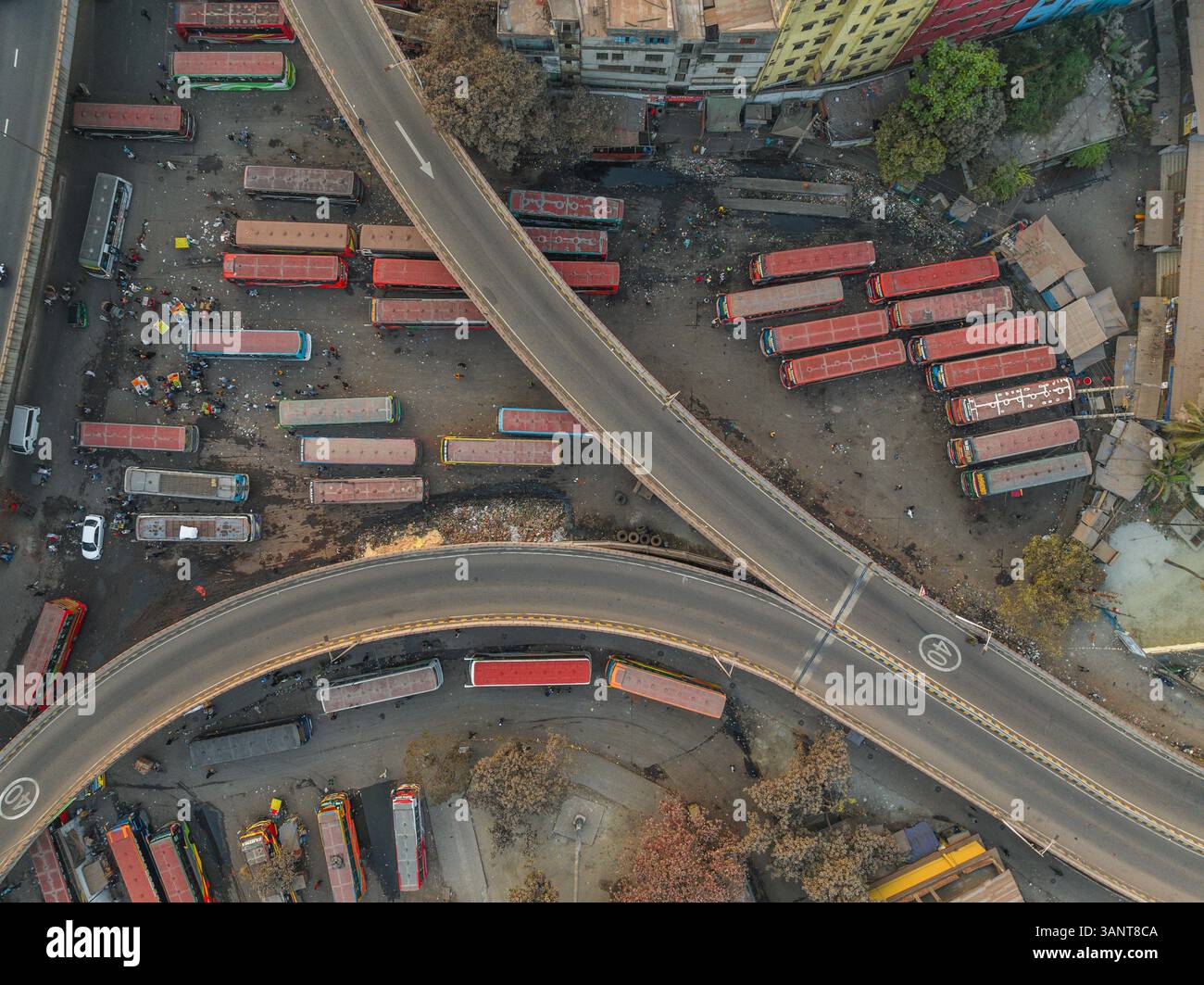 Aerial view of bustling junction road and bus station with vibrant city ...